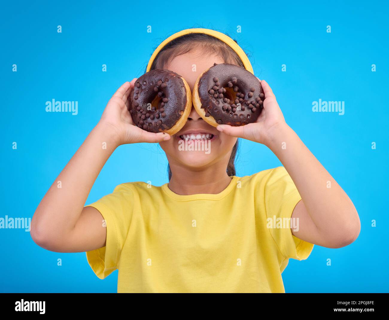 Donut, eyes and covering face of playful cute girl with food isolated ...
