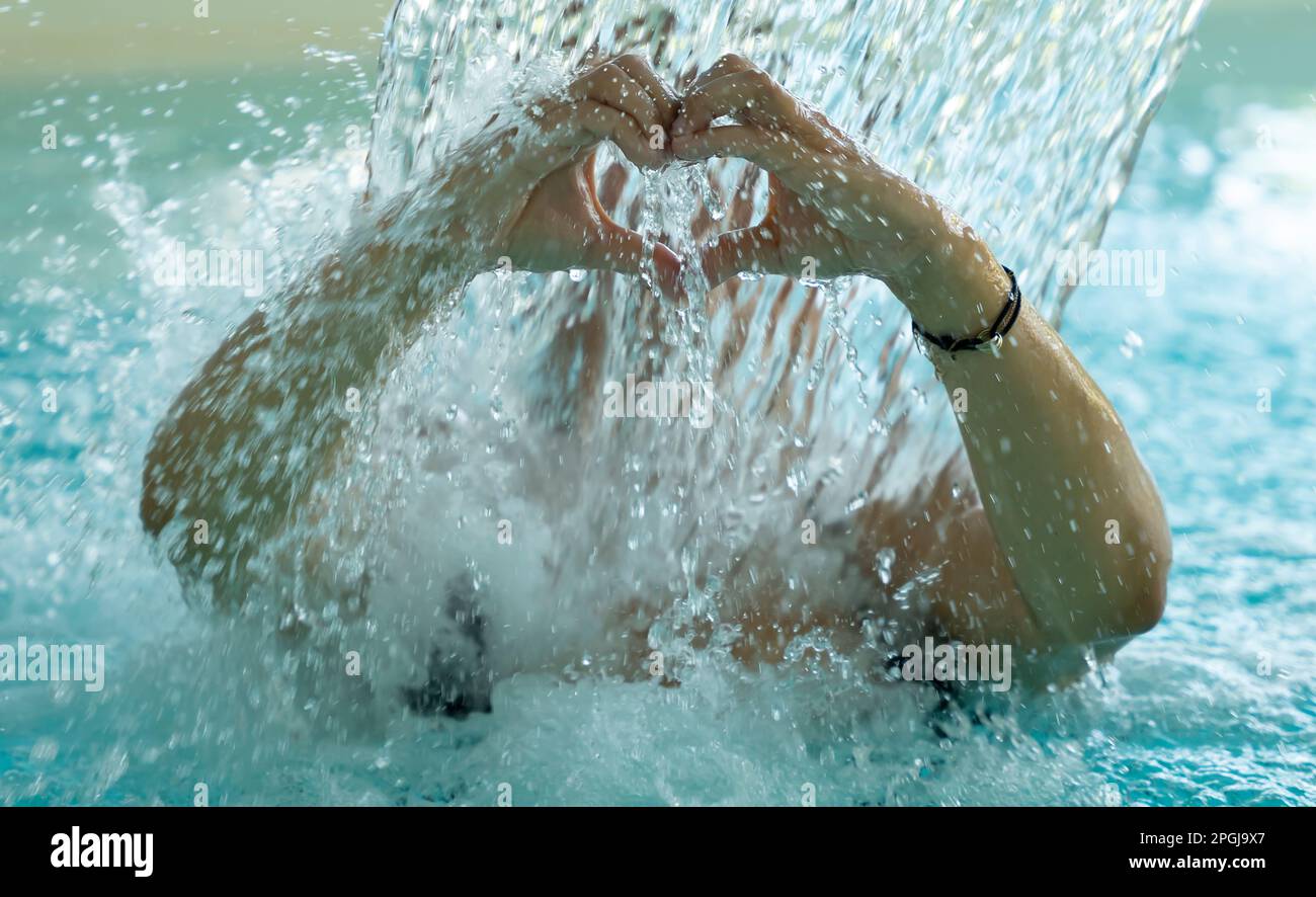 Woman Making a Heart Shape with Her Hands in a Hydromassage Pool with ...