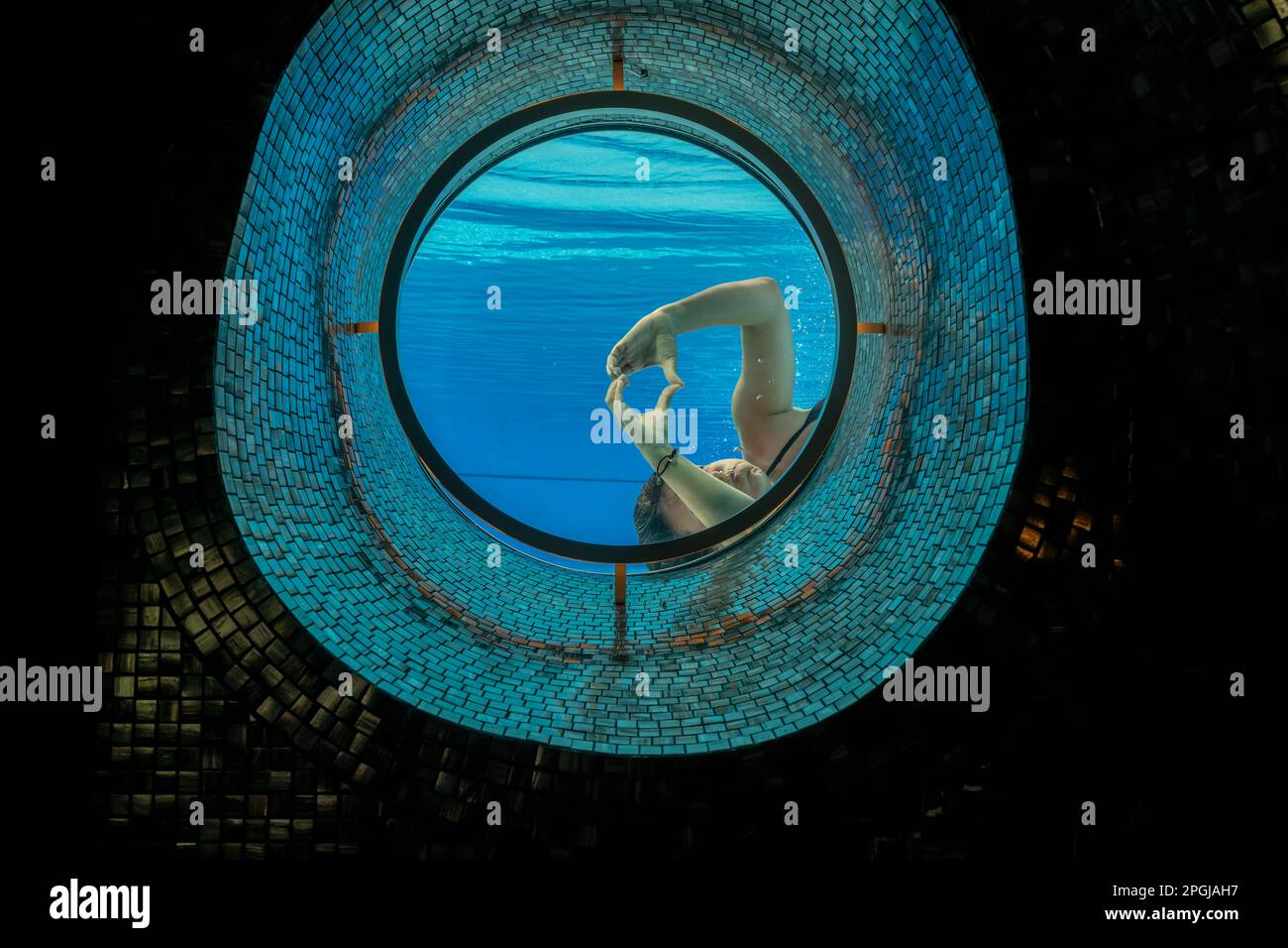 Woman Making a Heart Shape with Her Hands in the Ship Porthole in ...