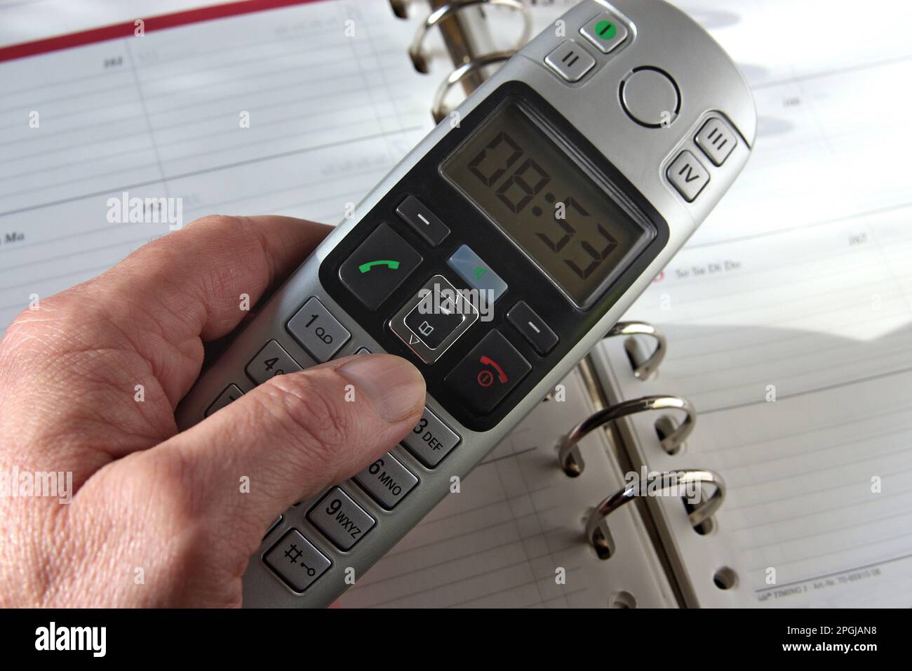 man with telephone receiver in the gand in front of diary Stock Photo ...