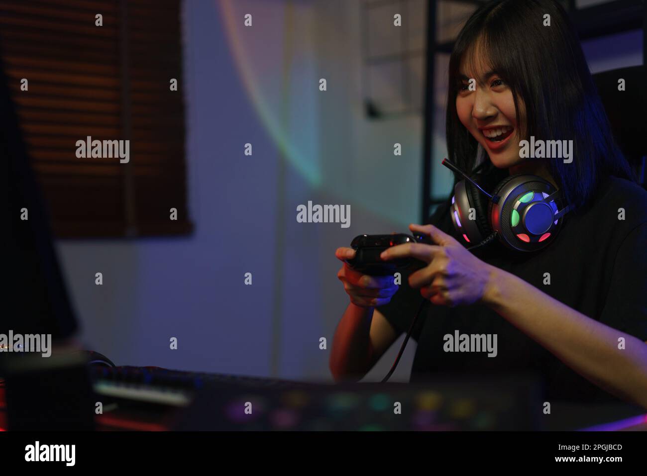 Female cyber hacker gamer using controller joystick to playing games on ...