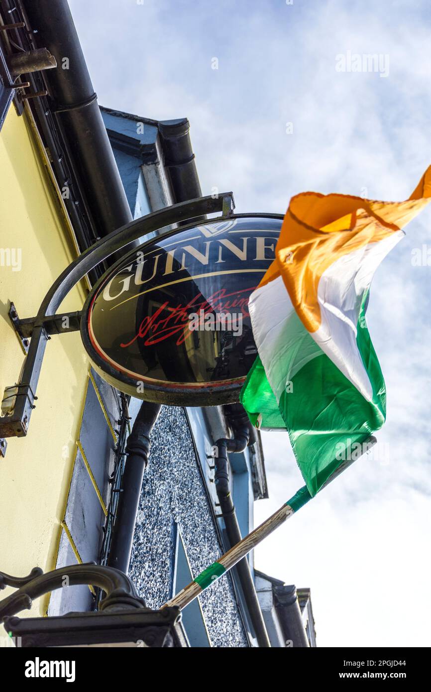 Irish tricolor national flag and Guinness sign outside a bar in County ...