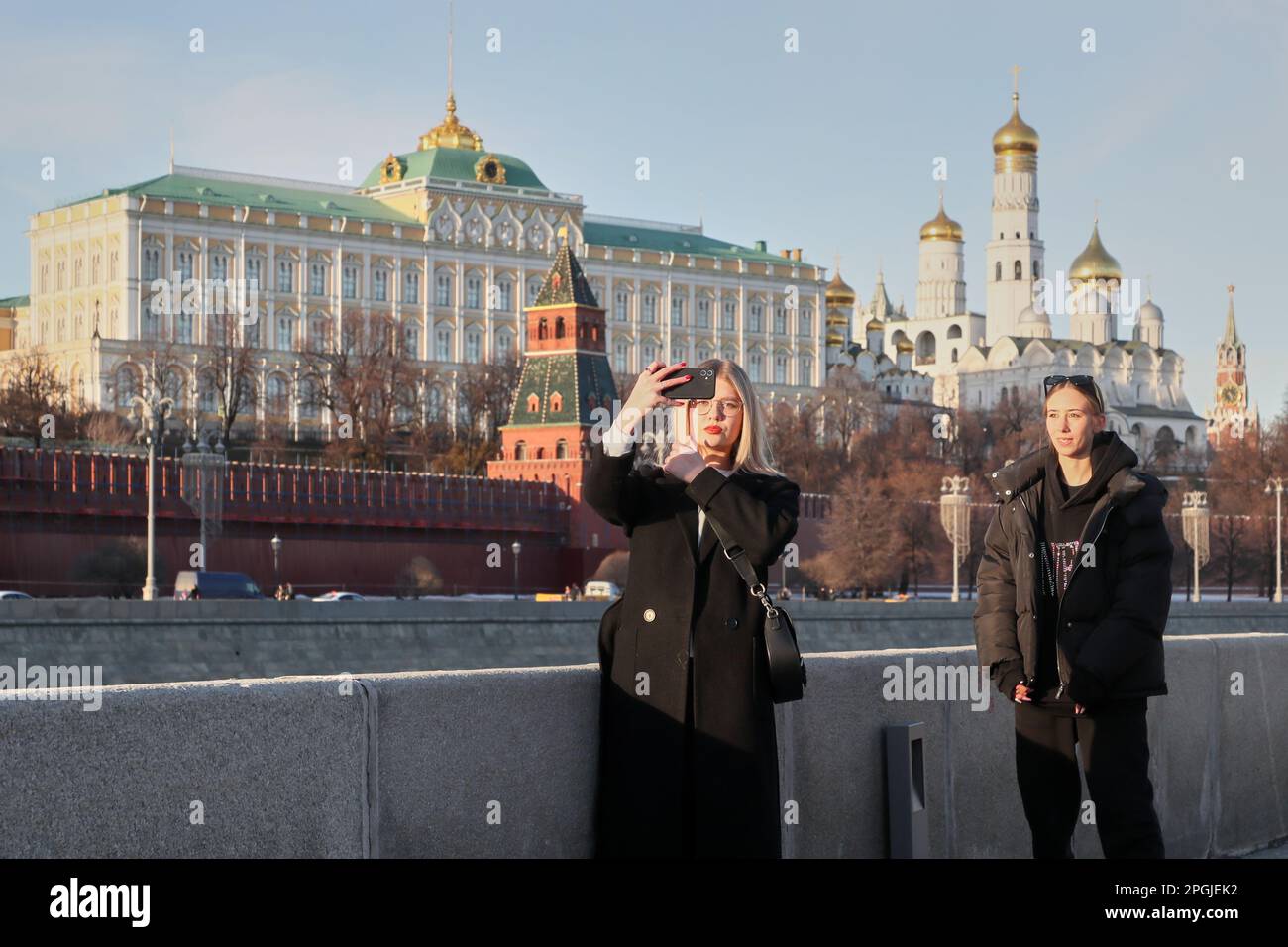 Young girls are photographed against the background of the Kremlin in ...