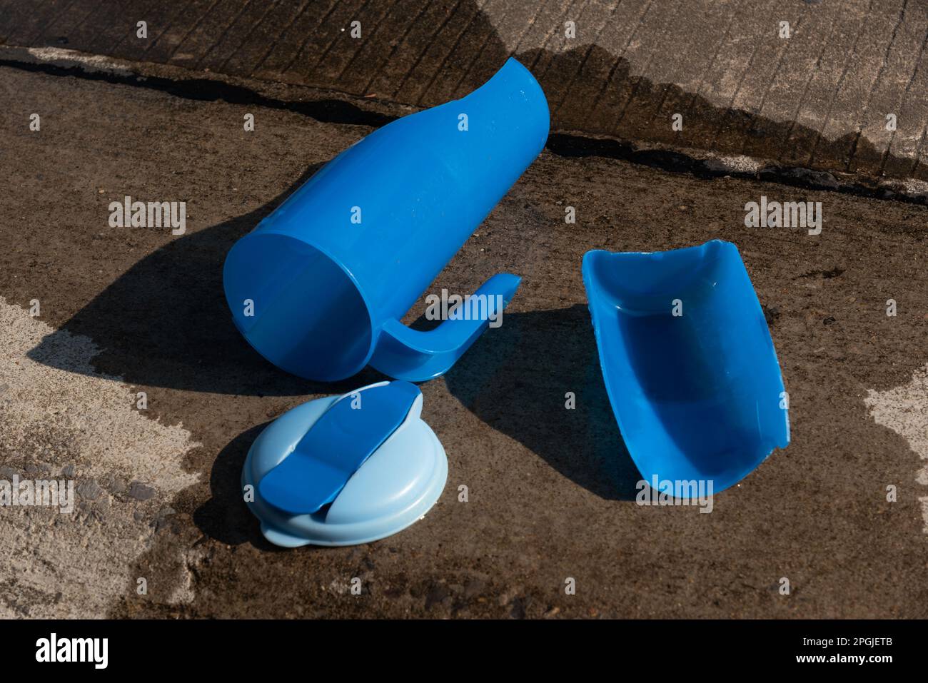 Broken plastic water bottle after falling on the ground Stock Photo - Alamy