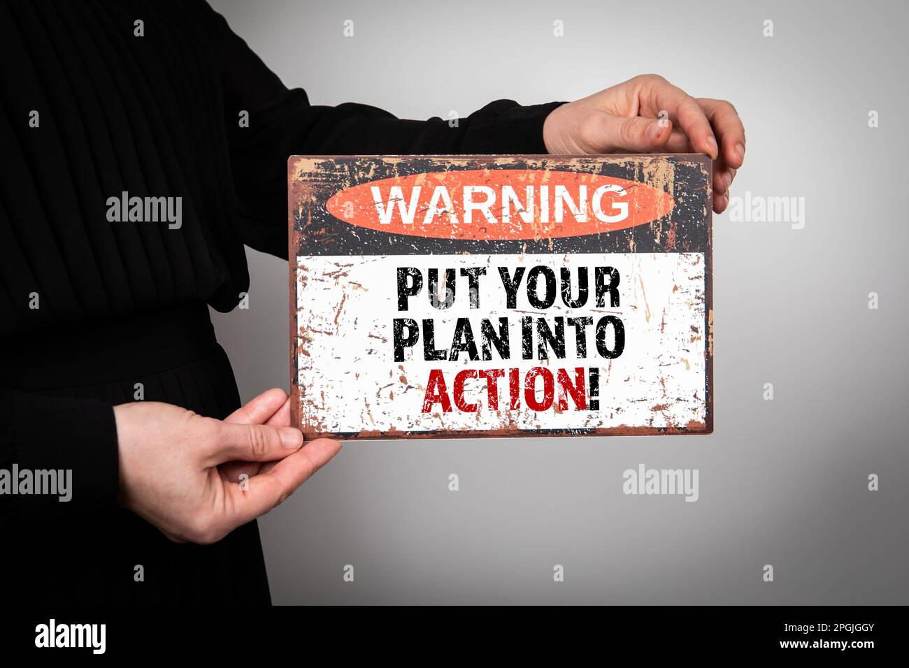 Put your plan into action. Warning sign with text Stock Photo - Alamy