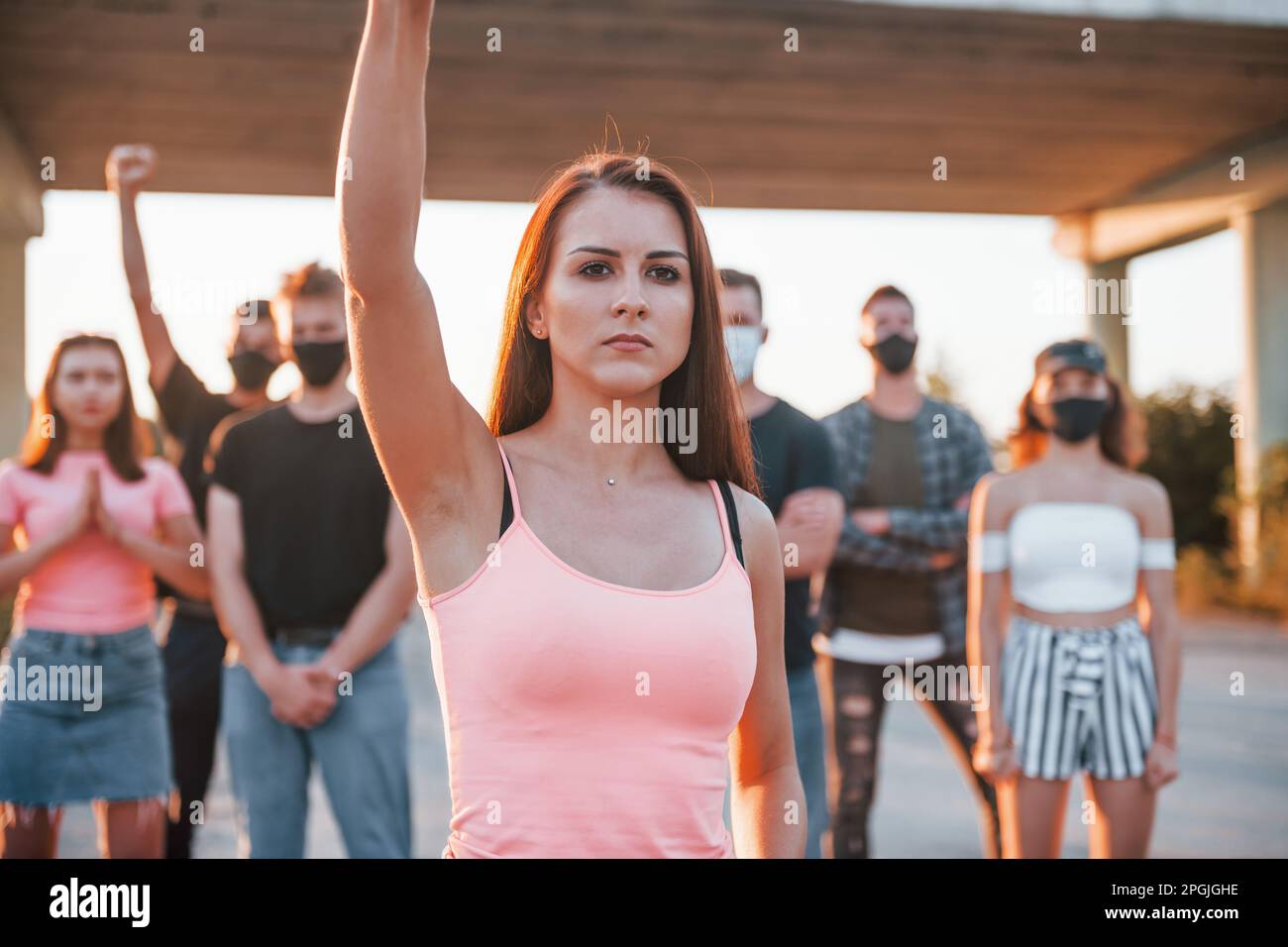 Woman on the front of crowd. Group of protesting young people that ...