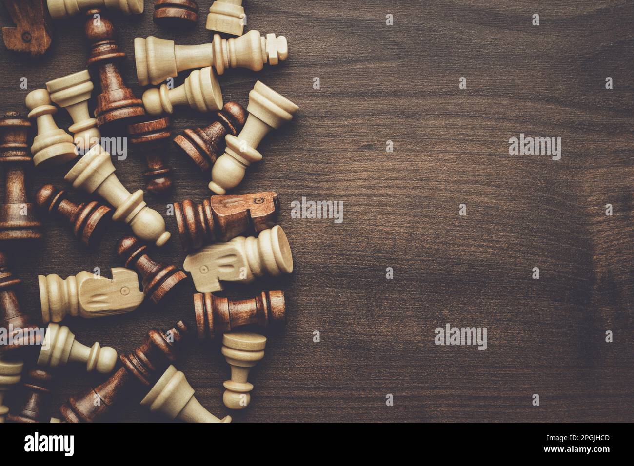 chess figures on the brown wooden table background Stock Photo - Alamy