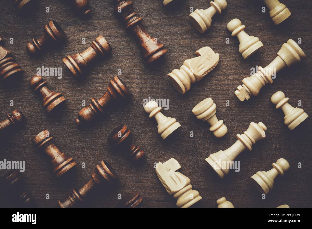 chess figures on the brown wooden table background Stock Photo - Alamy