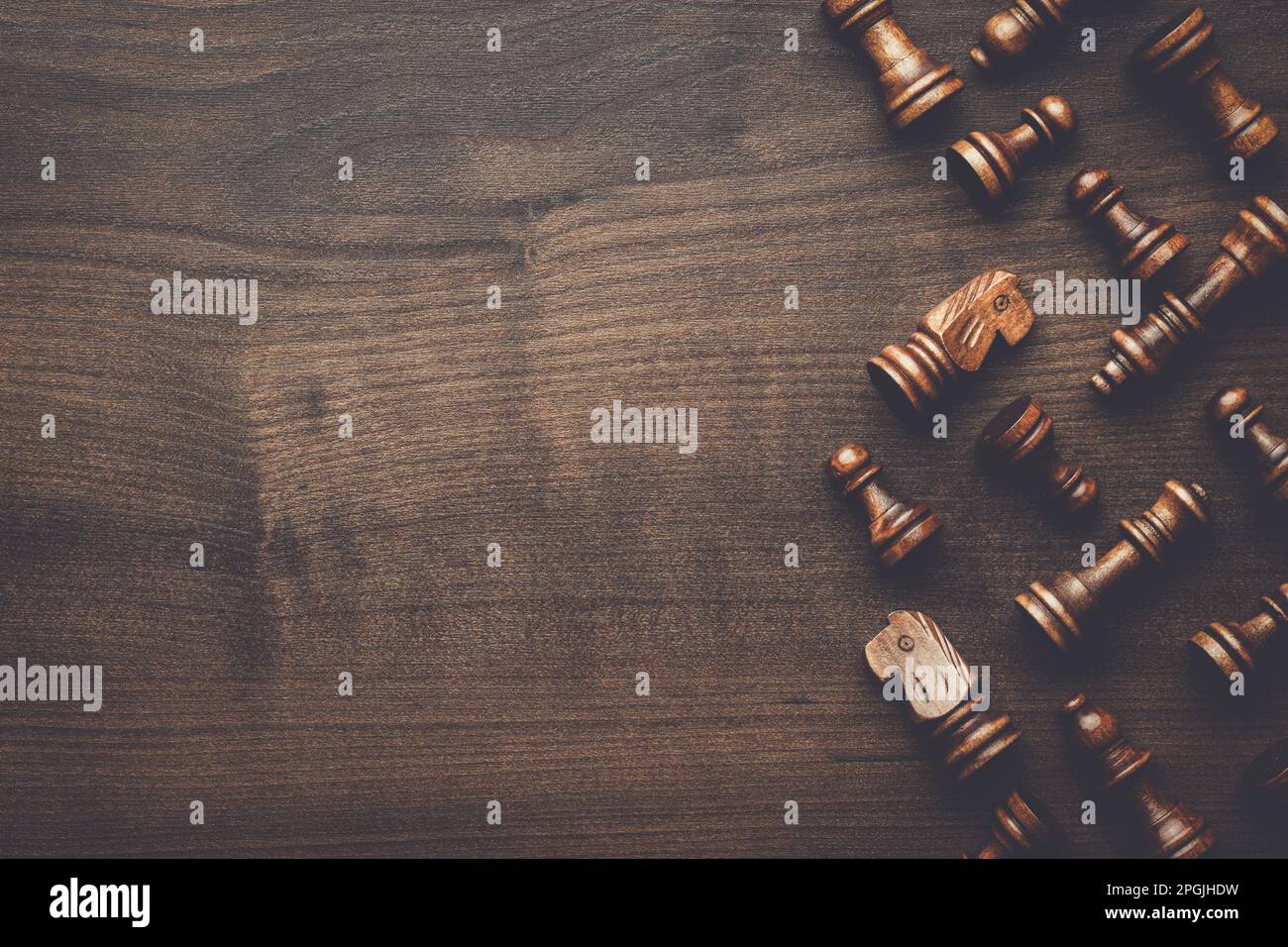 chess figures on the brown wooden table background Stock Photo - Alamy