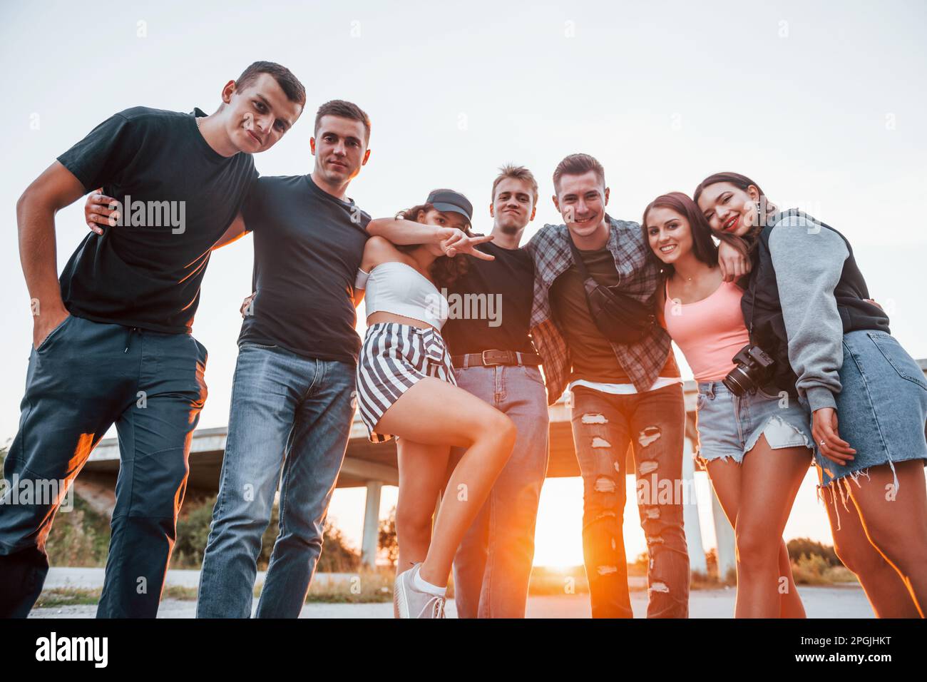 Embracing each other. Group of young cheerful friends having fun ...