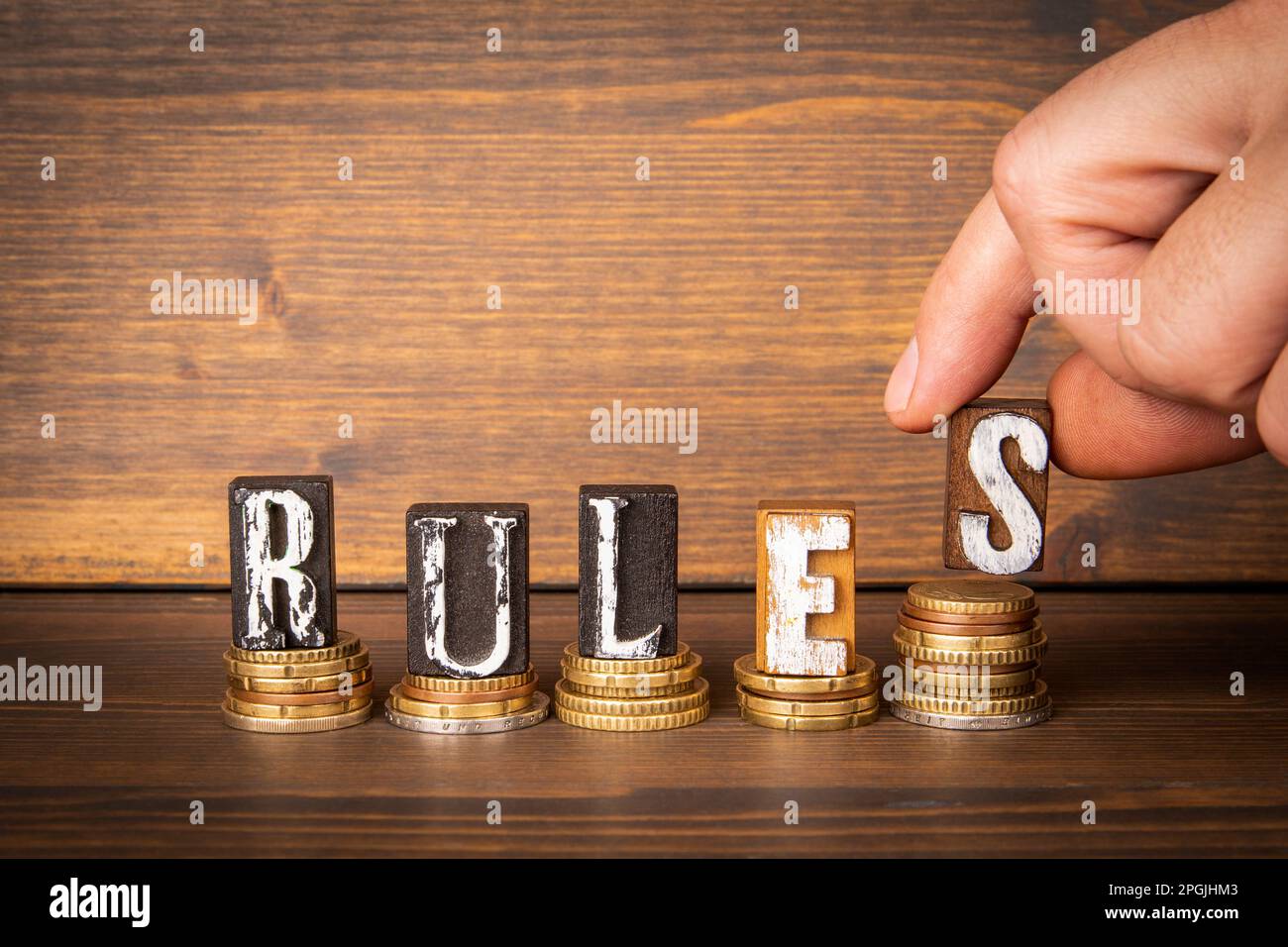 RULES. Alphabet letters and change on wood texture background Stock ...