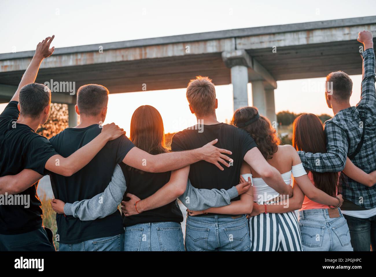 View from behind. Group of young cheerful friends having fun together ...