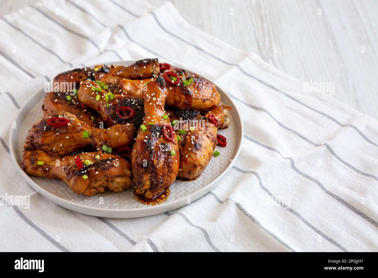 Homemade Easy Sticky Chicken Drumsticks on a Plate, side view. Space ...