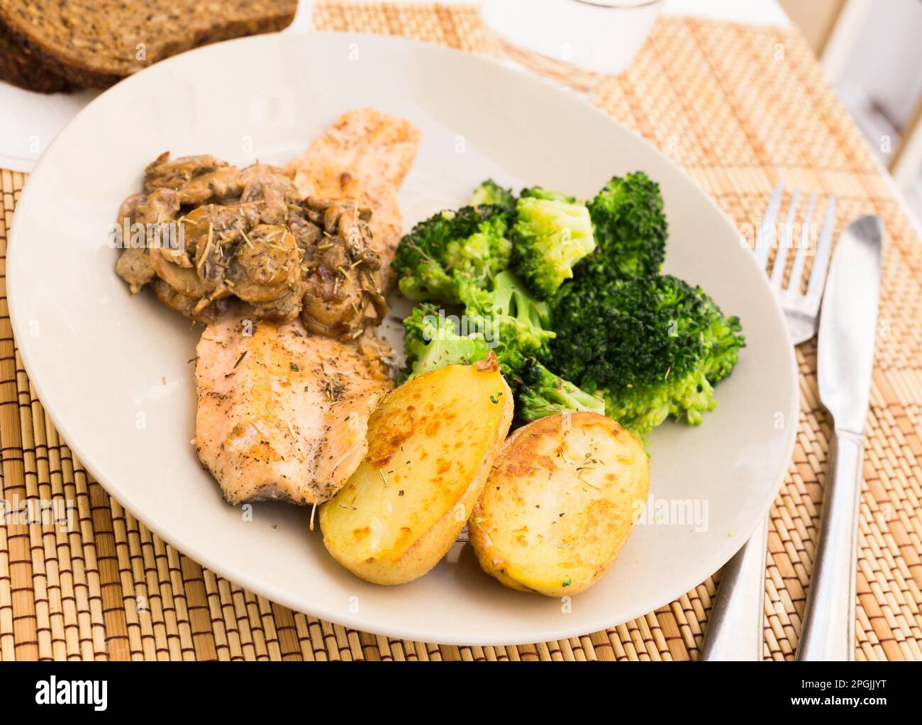 fried river trout fillet with a complex side dish of broccoli, baked ...