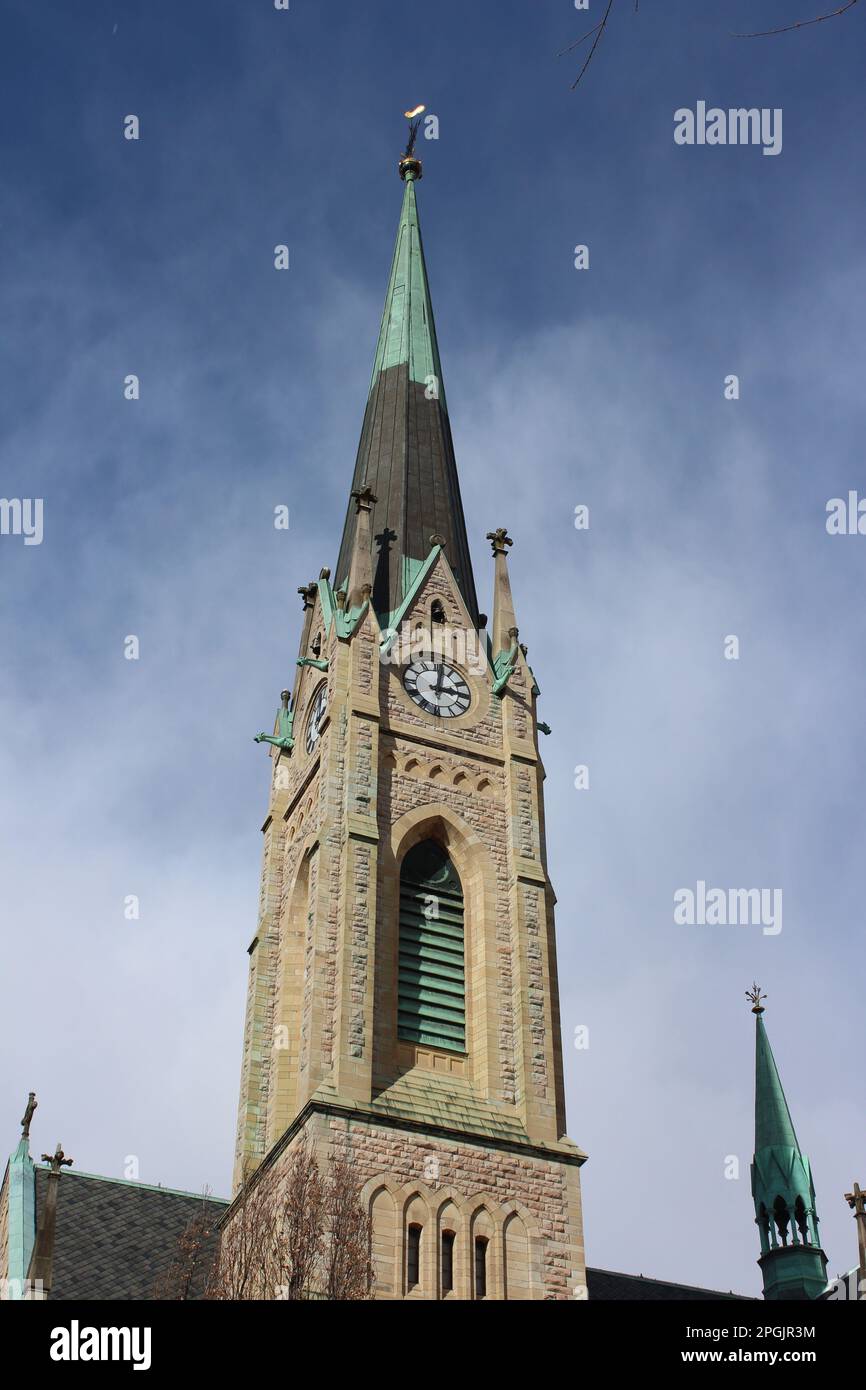 An architectural shot of a vintage clock tower in a rural setting ...