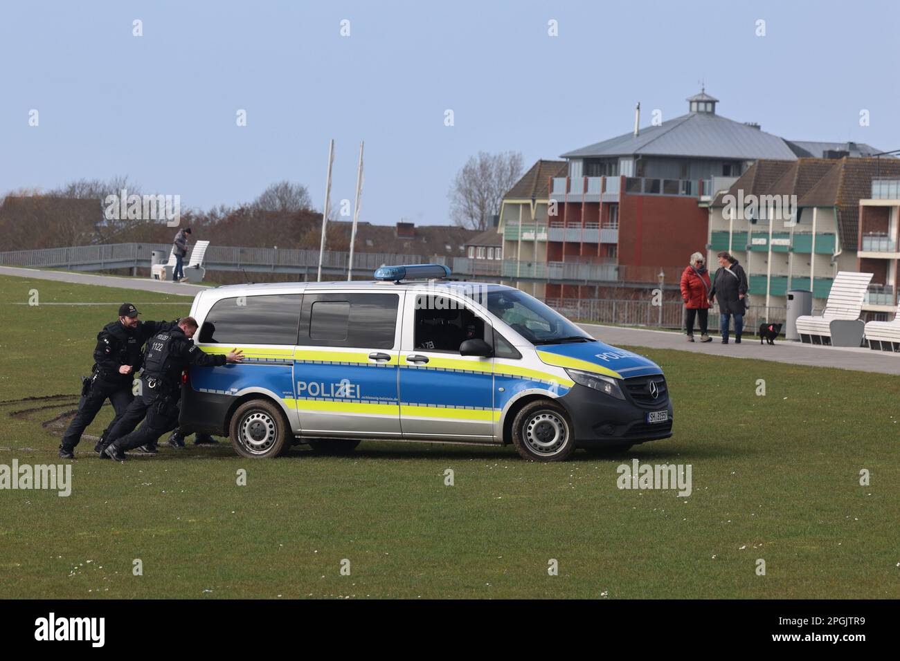 23 March 2023, Schleswig-Holstein, Büsum: Police officers push a patrol ...