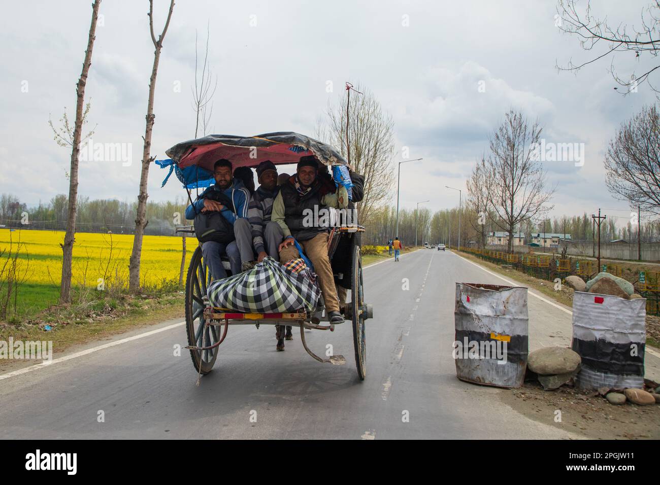 Kashmiri passengers are seen sitting on horse drawn cart locally known ...