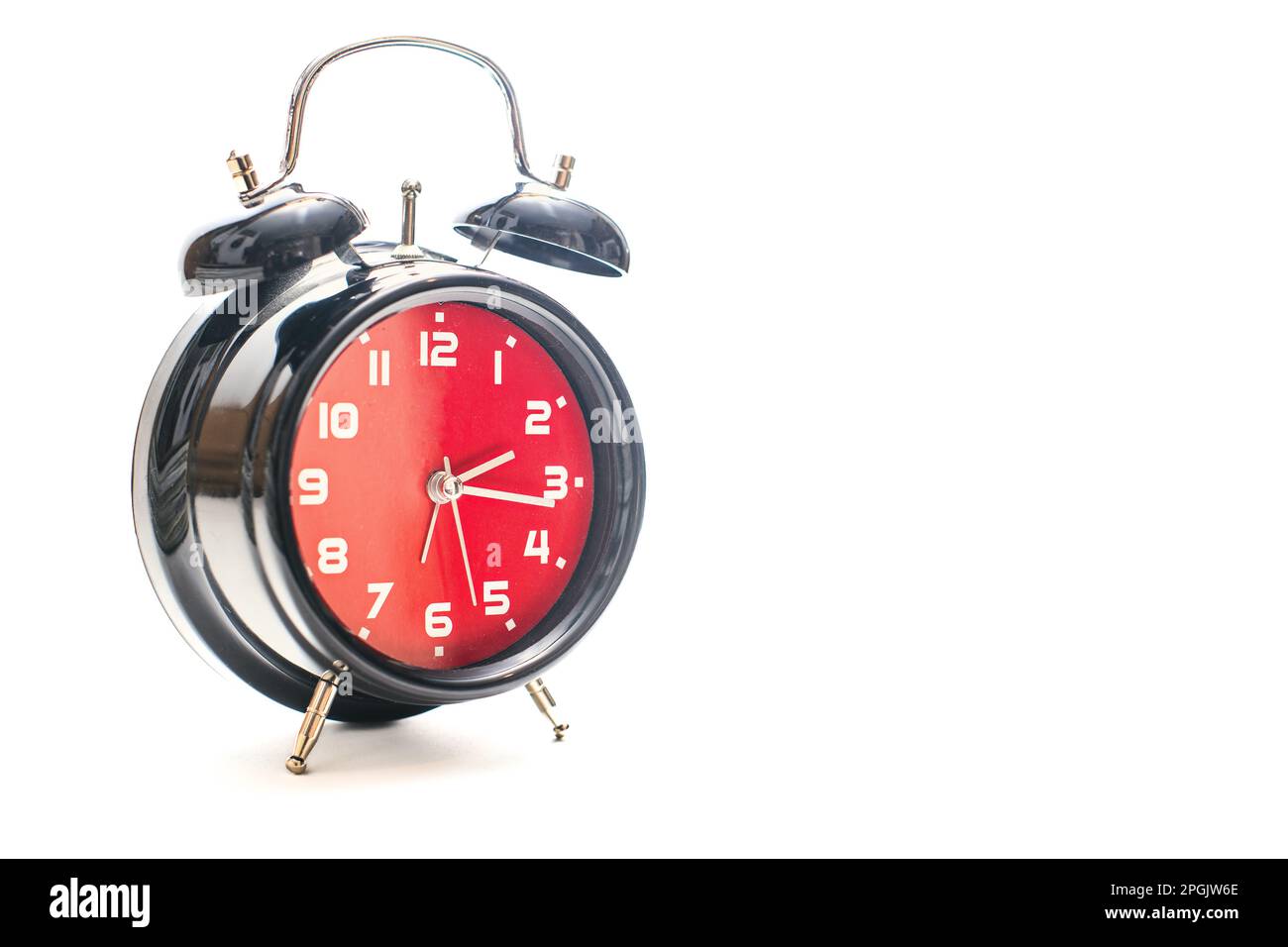 A red and black alarm clock on white background Stock Photo - Alamy