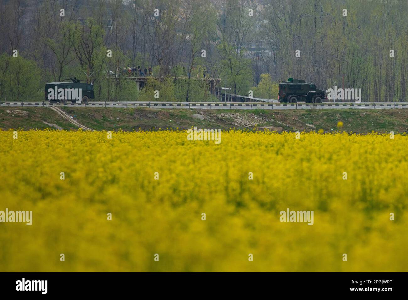 Indian army vehicles patrol on Kashmir's main highway alongside a ...