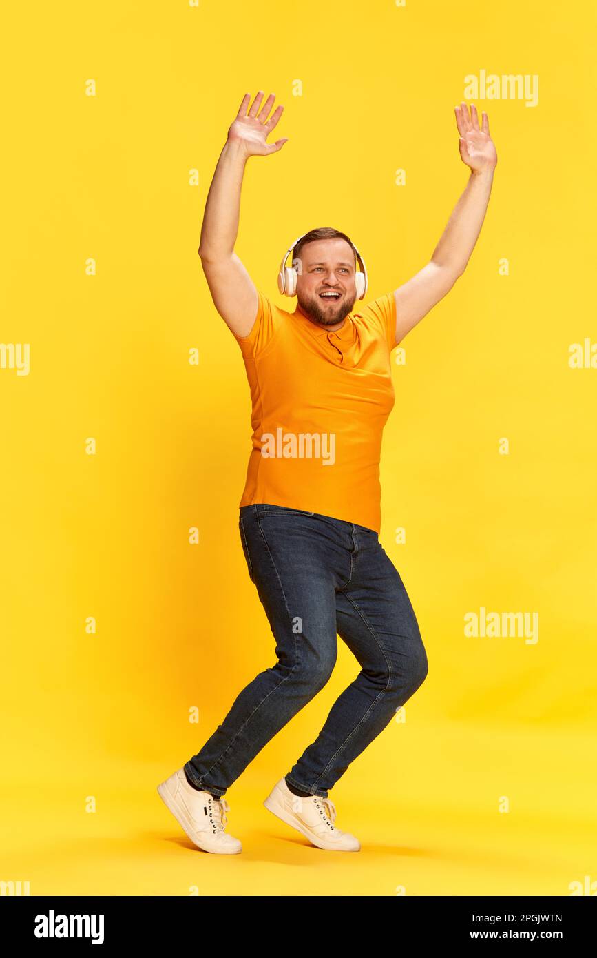 One smiling man jumping, dancing to music with enjoying face over ...