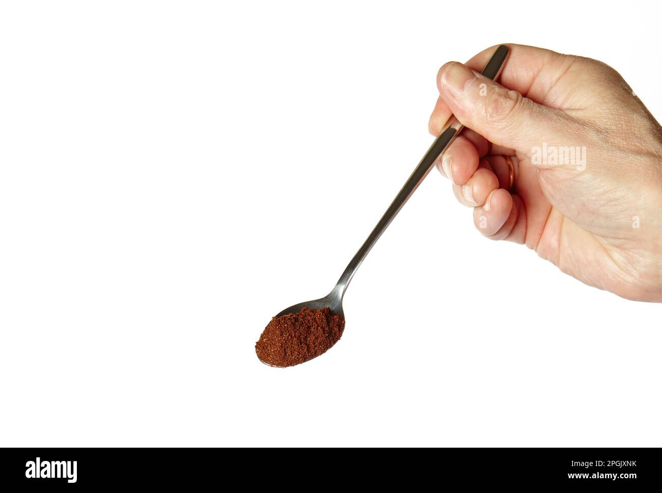 Men's hand holding spoon with coffee powder isolated white background ...