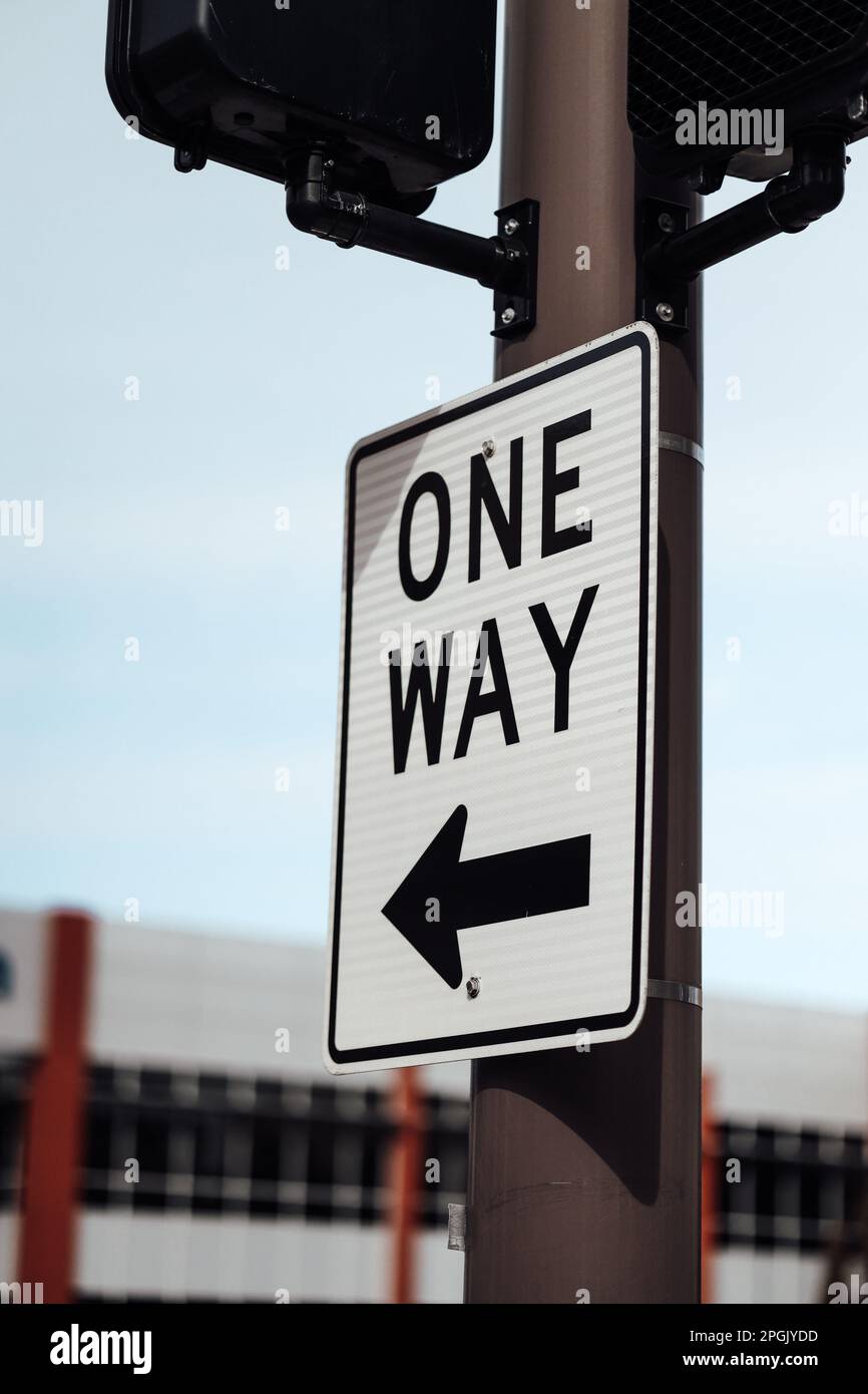 A "one way" sign on a black and white street signboard Stock Photo - Alamy