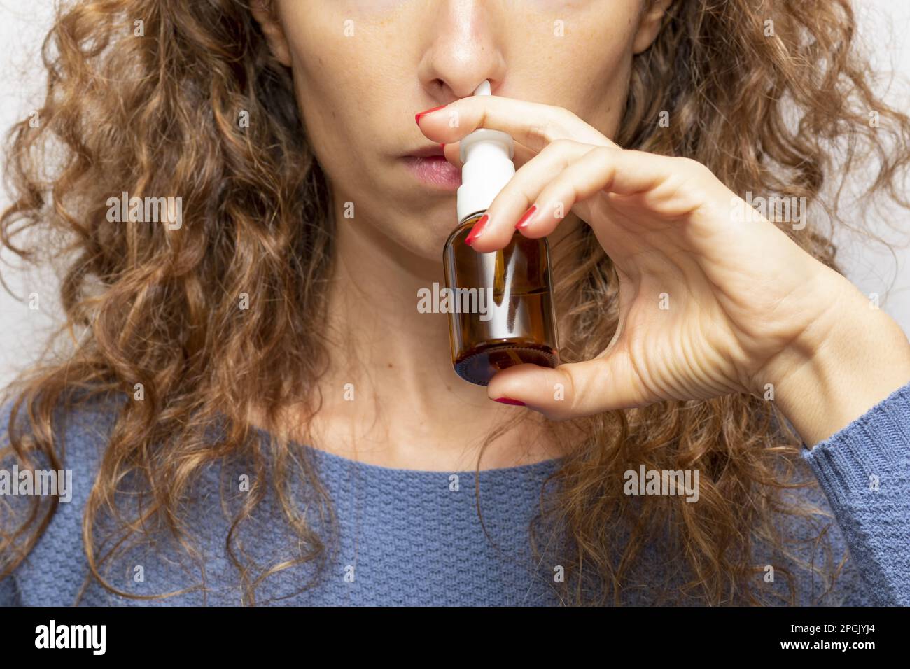 Woman with sick with a rhinitis. Taking nose drops because of pollen ...