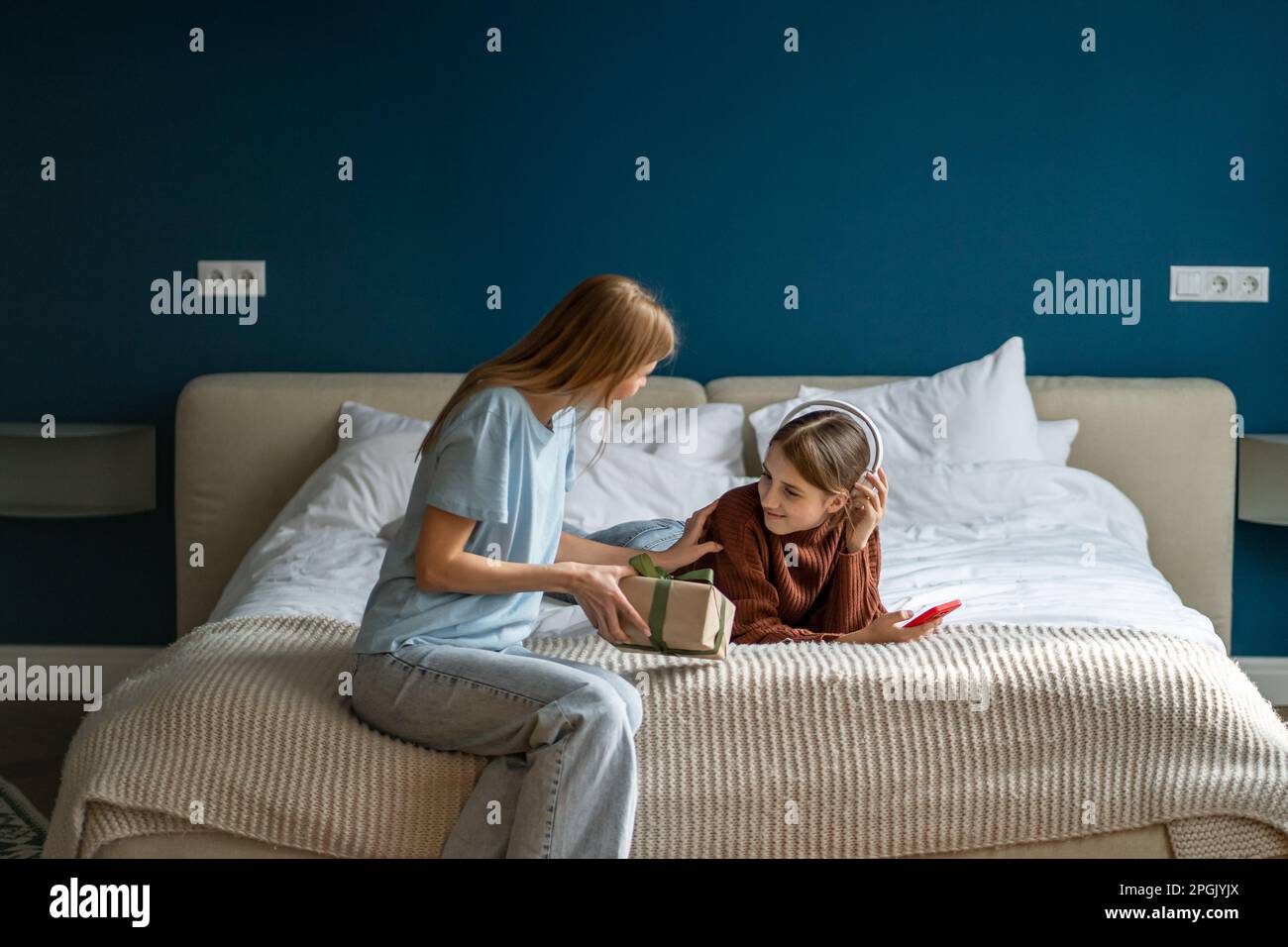 Caring attentive woman mother congratulate beloved teen daughter with ...