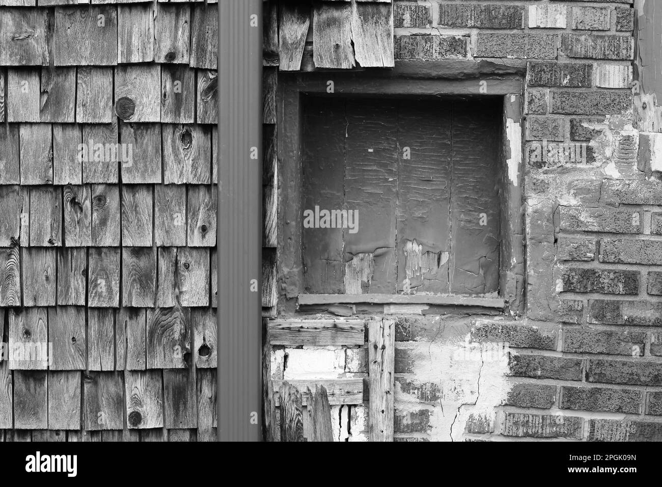 An old worn and weathered brick building blocked with plywood infill in ...