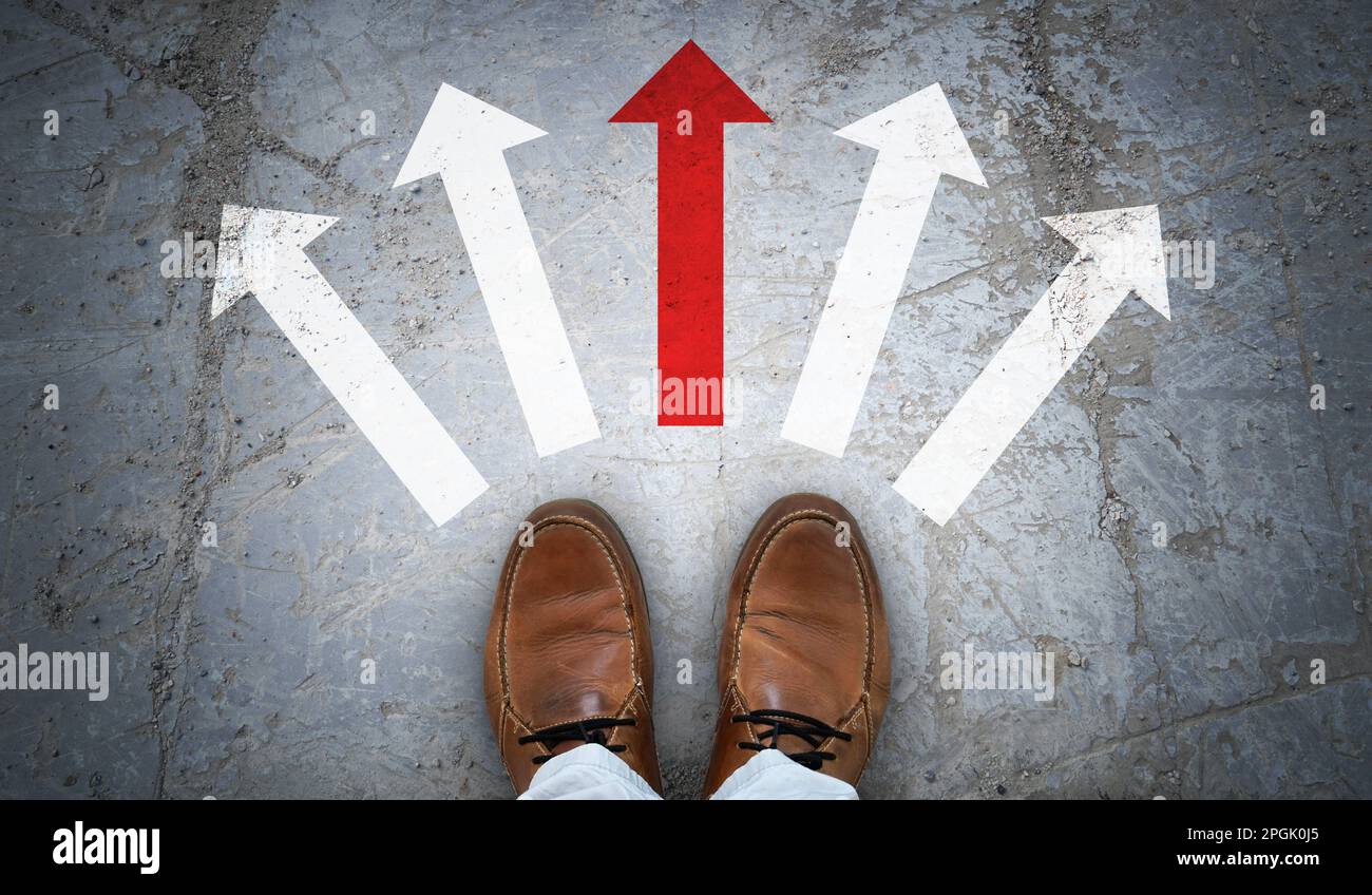 Brown leather shoes and five chalky arrows on asphalt - choice concept ...