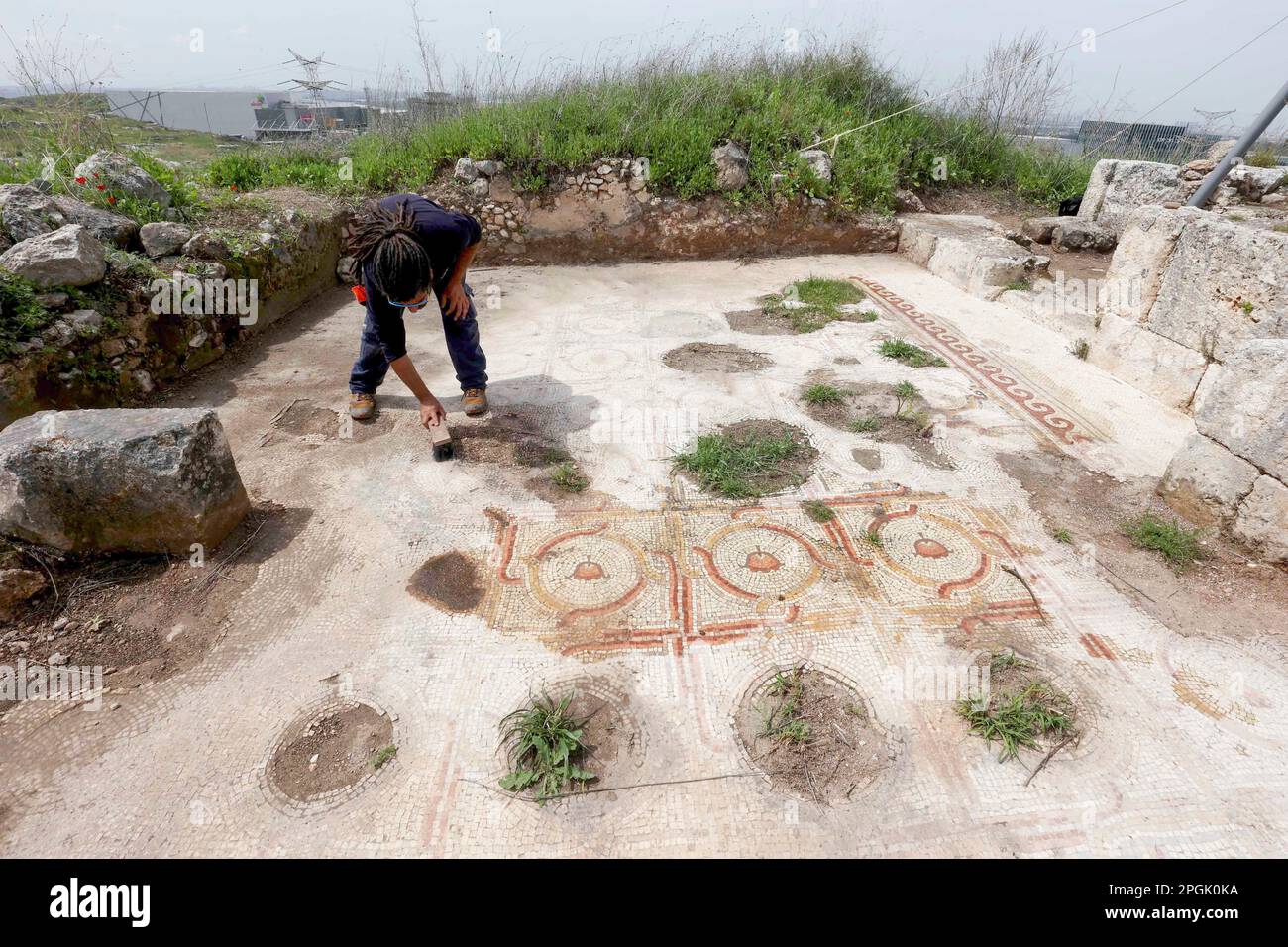 Shoham. 22nd Mar, 2023. An employee of the Israel Antiquities Authority ...