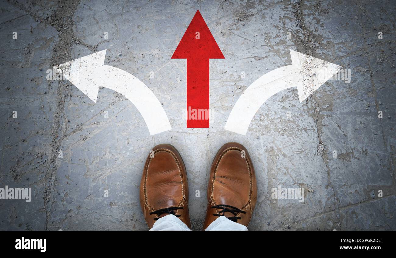 Brown leather shoes and three chalky arrows on asphalt - choice concept ...