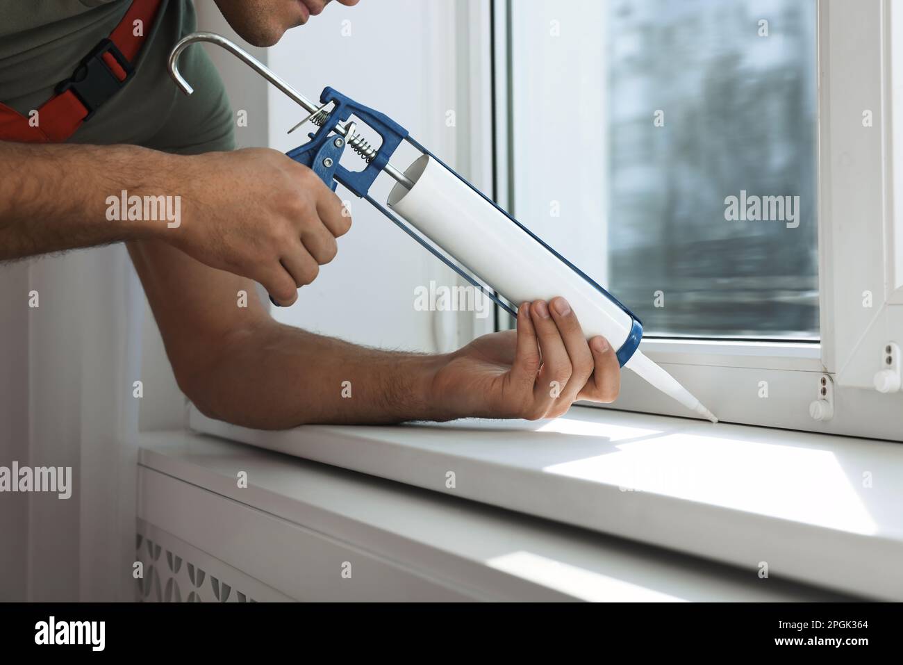 Construction worker sealing window with caulk indoors, closeup Stock ...