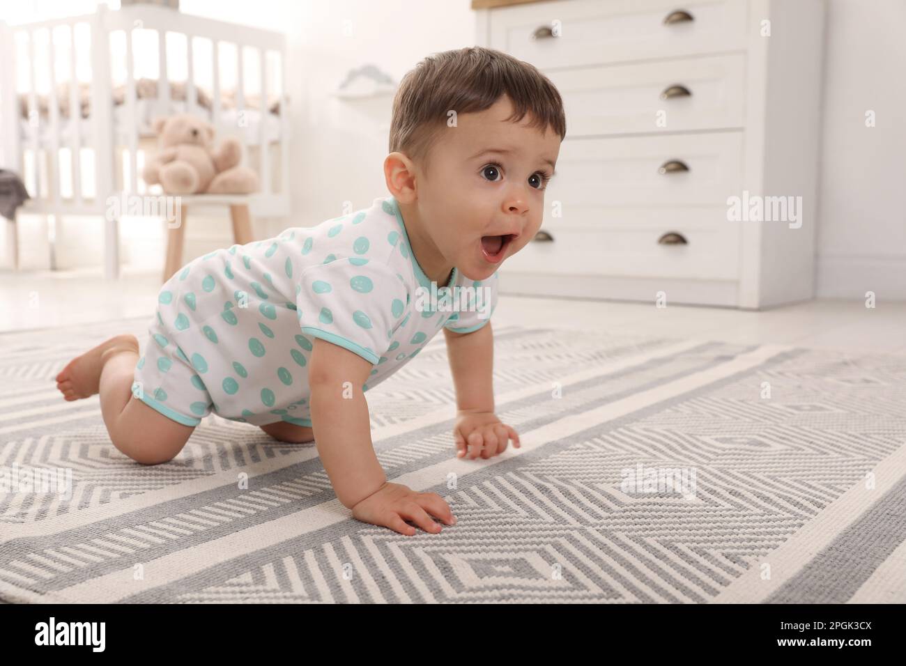 Cute baby crawling on floor at home Stock Photo - Alamy