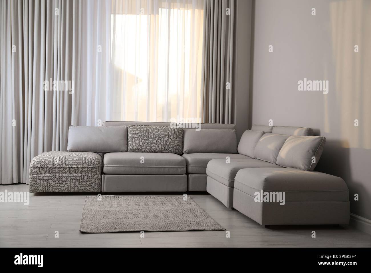 Large grey sofa in living room. Interior design Stock Photo - Alamy