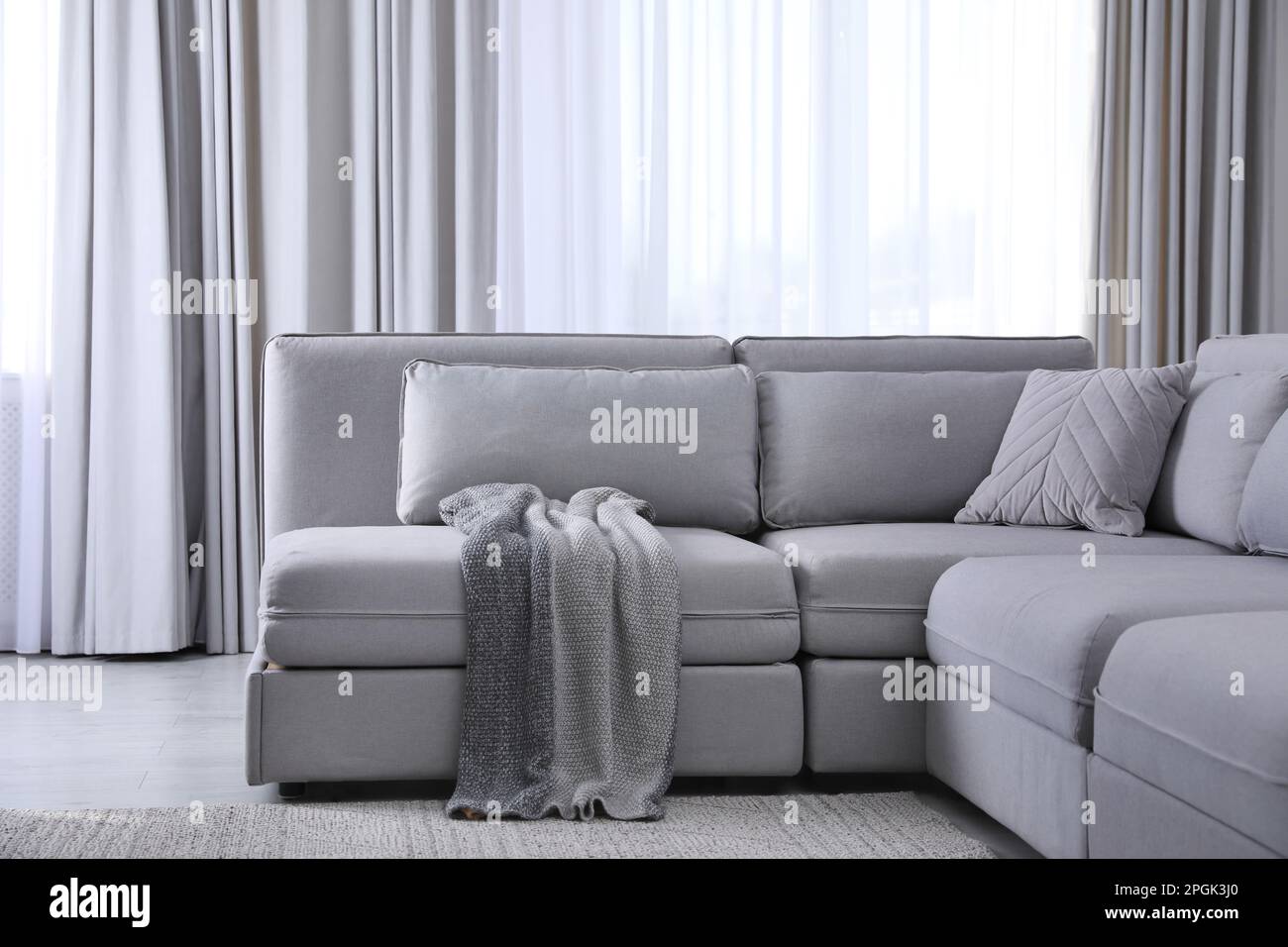 Large grey sofa in living room. Interior design Stock Photo - Alamy