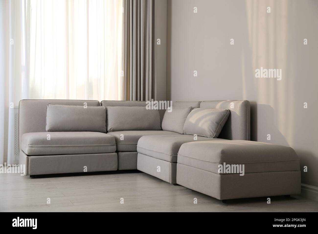 Large grey sofa in living room. Interior design Stock Photo - Alamy