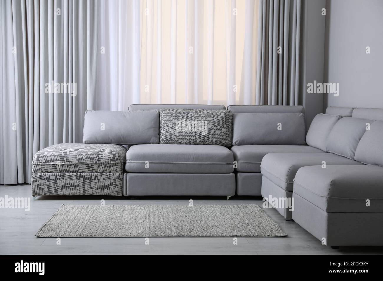 Large grey sofa in living room. Interior design Stock Photo - Alamy