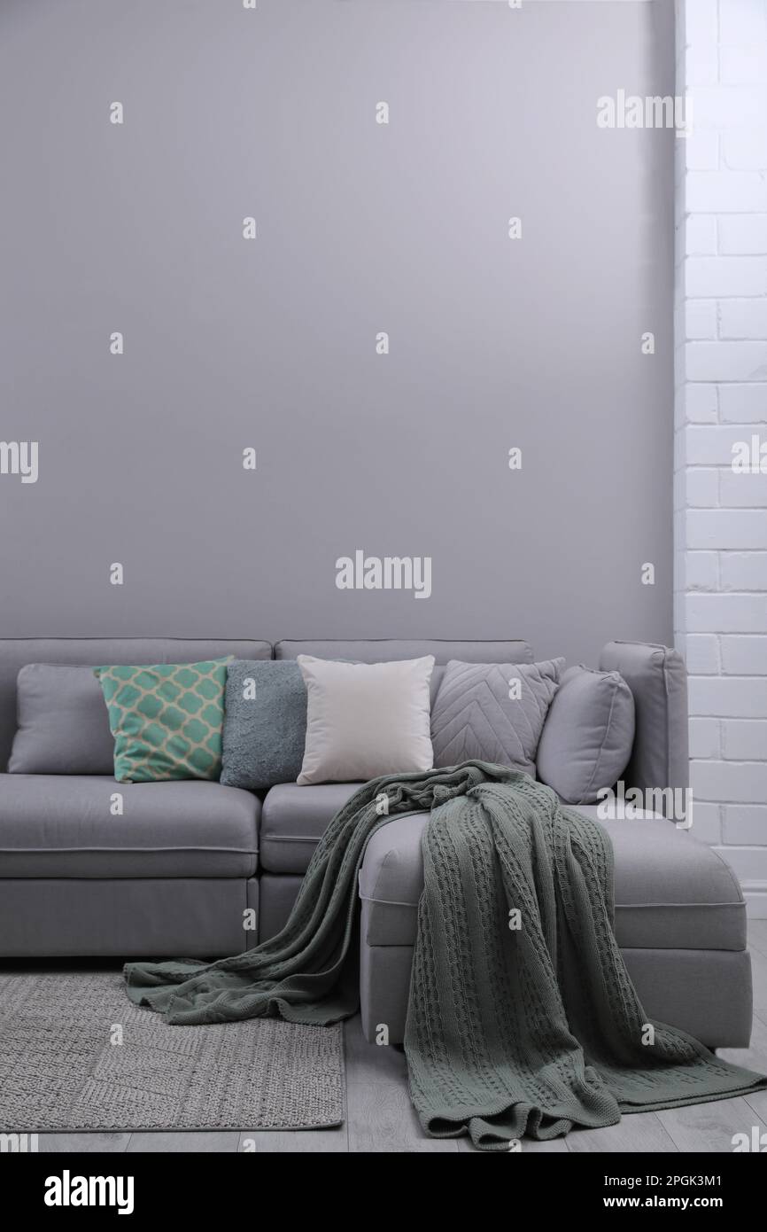 Large grey sofa in living room. Interior design Stock Photo - Alamy