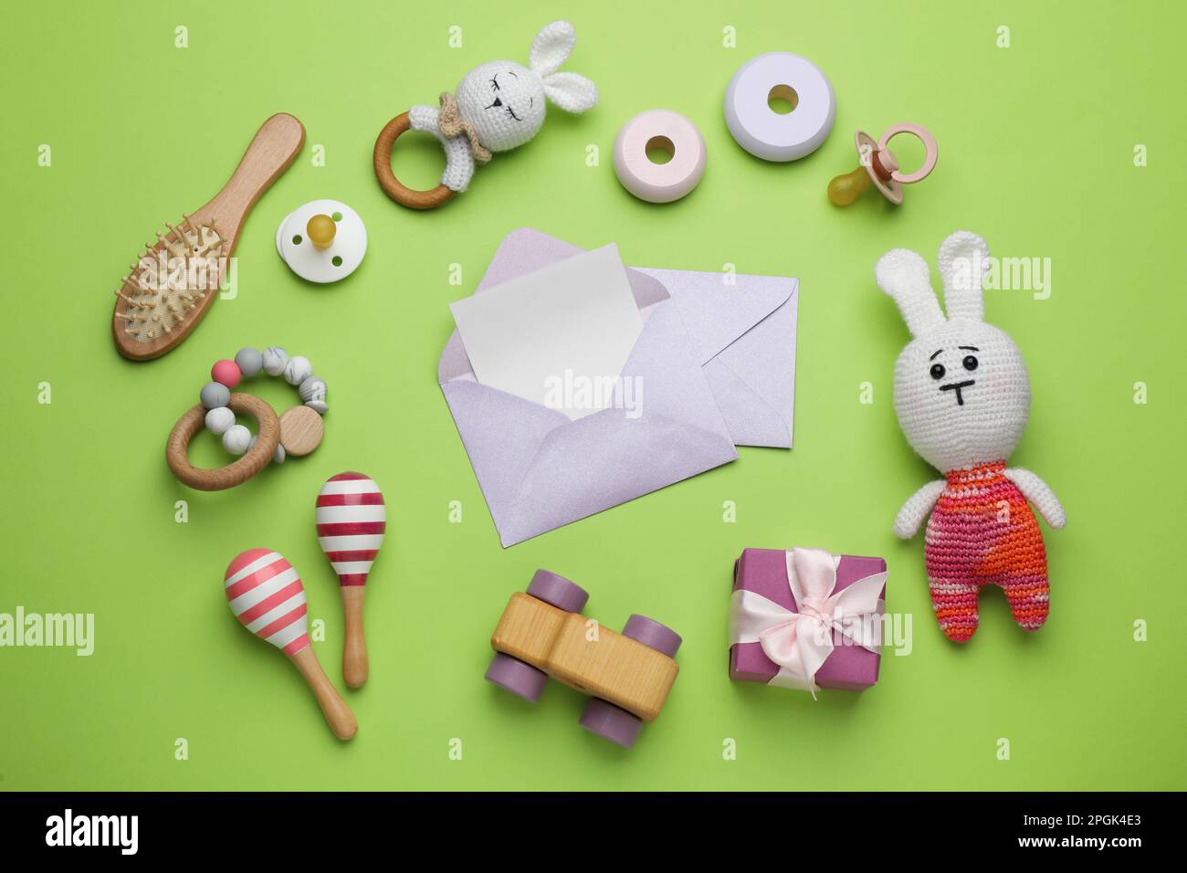 Envelopes for baby shower and accessories on light green background ...