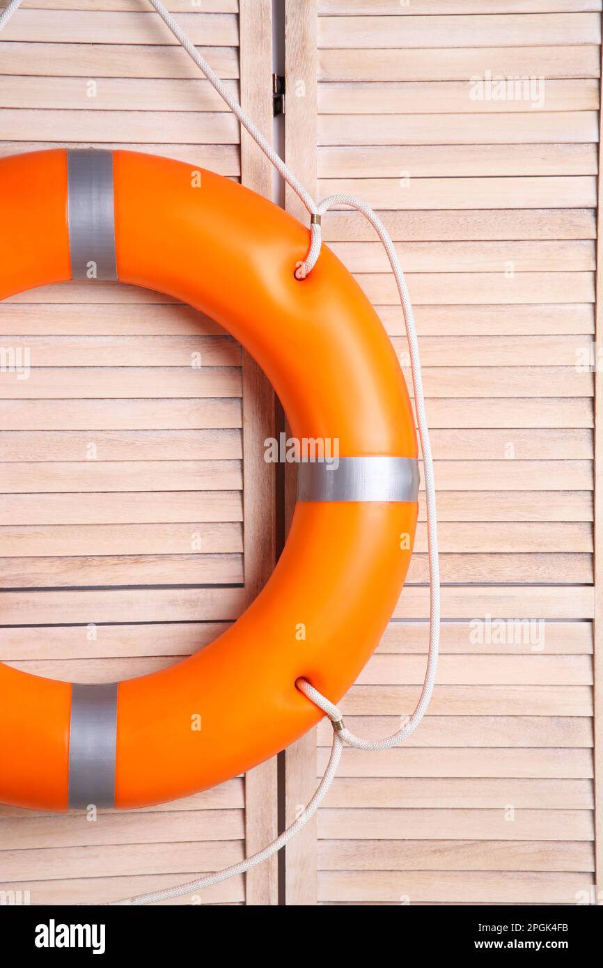Orange lifebuoy on wooden background. Rescue equipment Stock Photo - Alamy