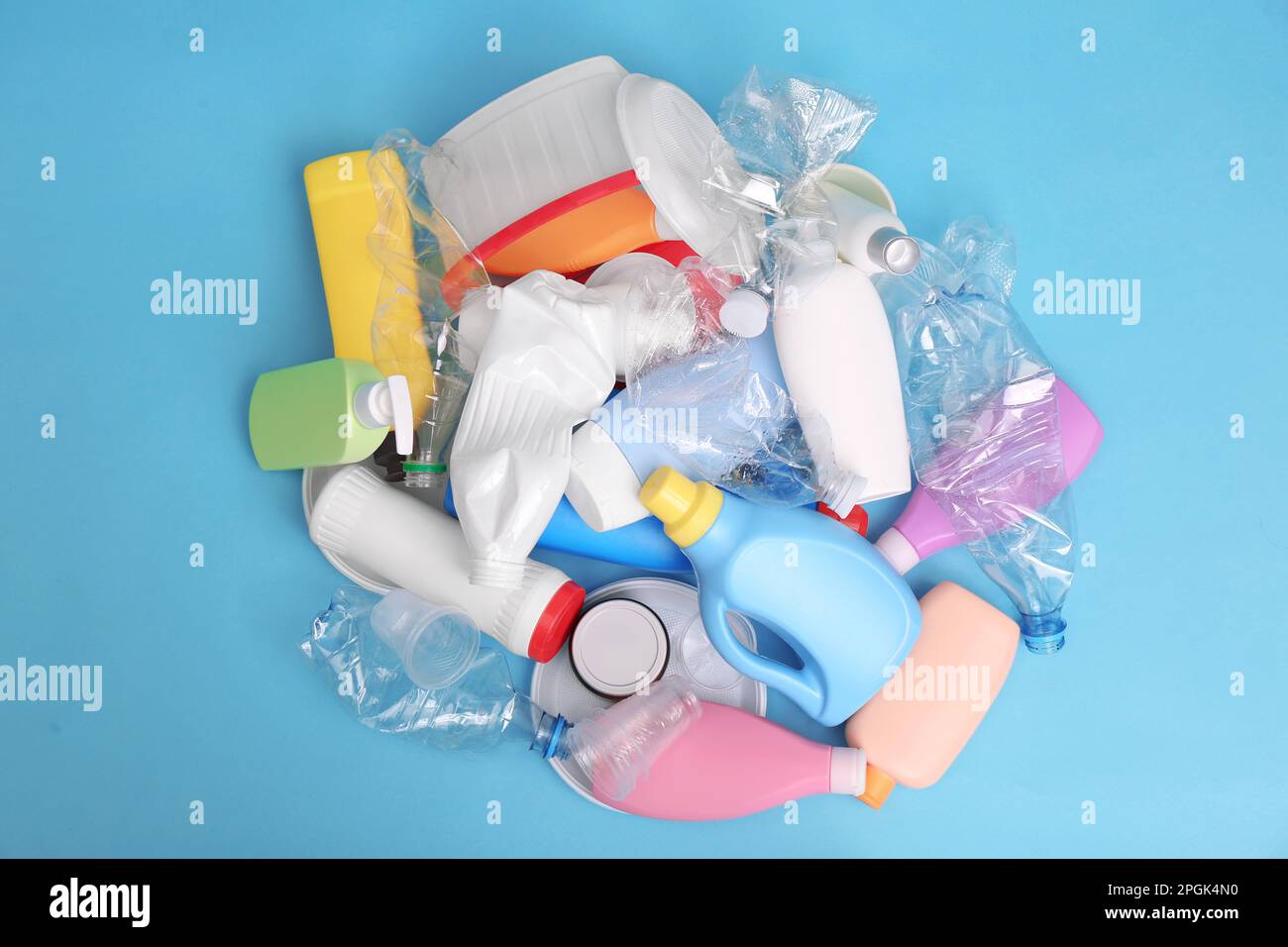 Pile of plastic garbage on light blue background, flat lay Stock Photo ...