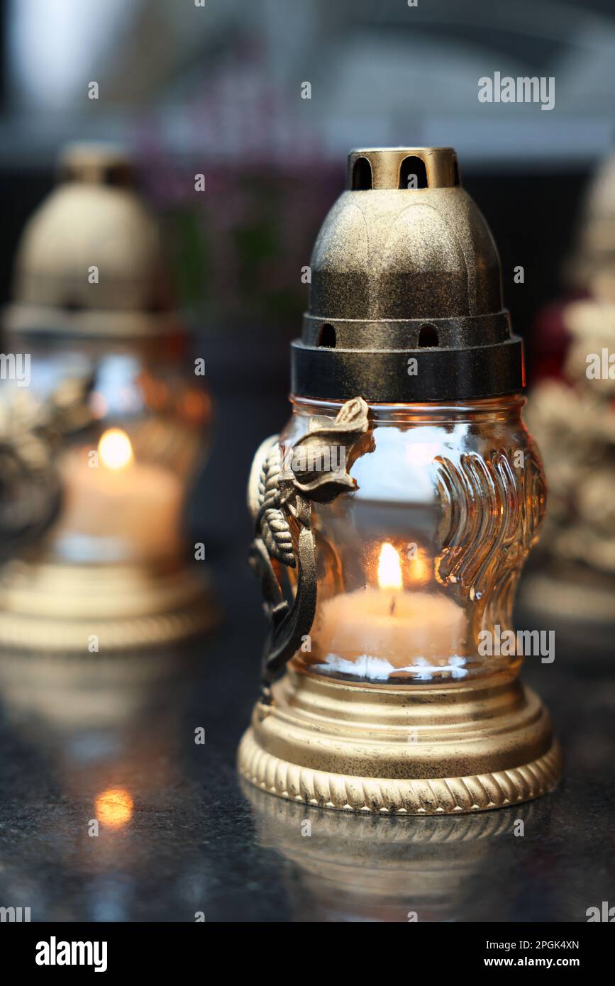 Grave lights on granite surface at cemetery, closeup Stock Photo - Alamy