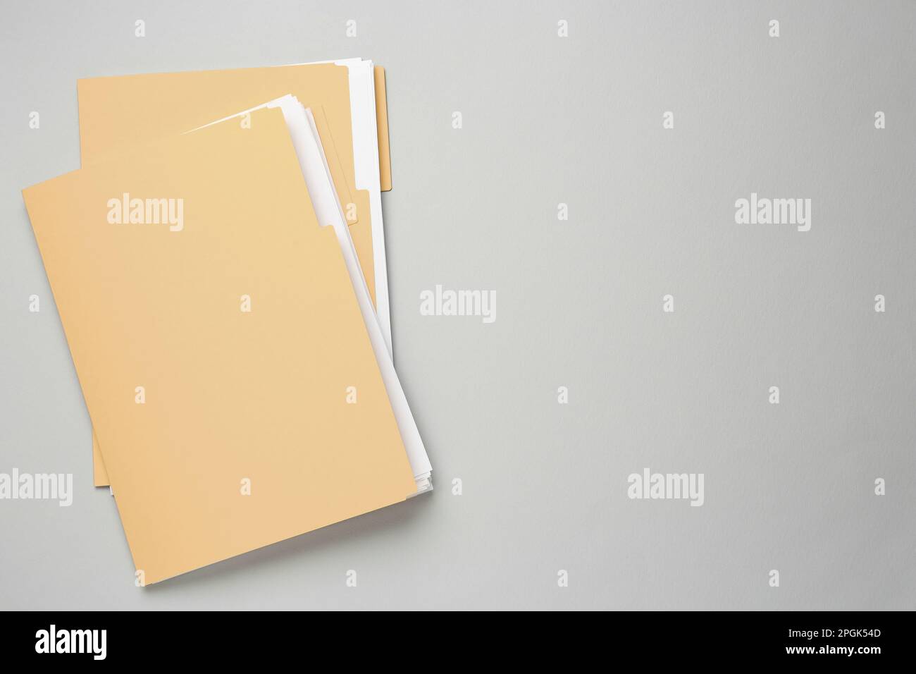 Yellow files with documents on light grey background, top view. Space ...