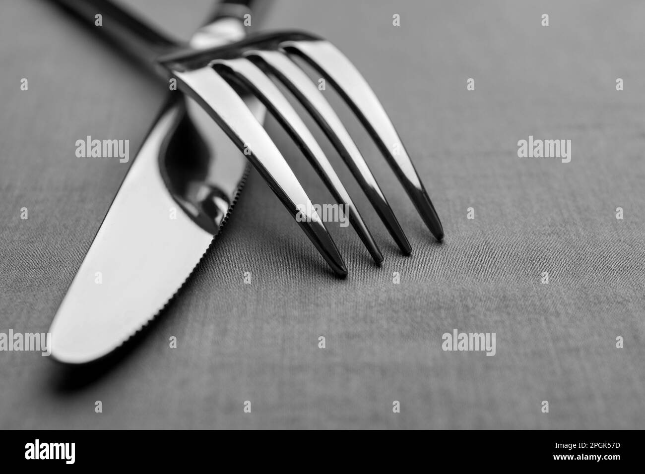Shiny fork and knife on grey table, closeup Stock Photo - Alamy