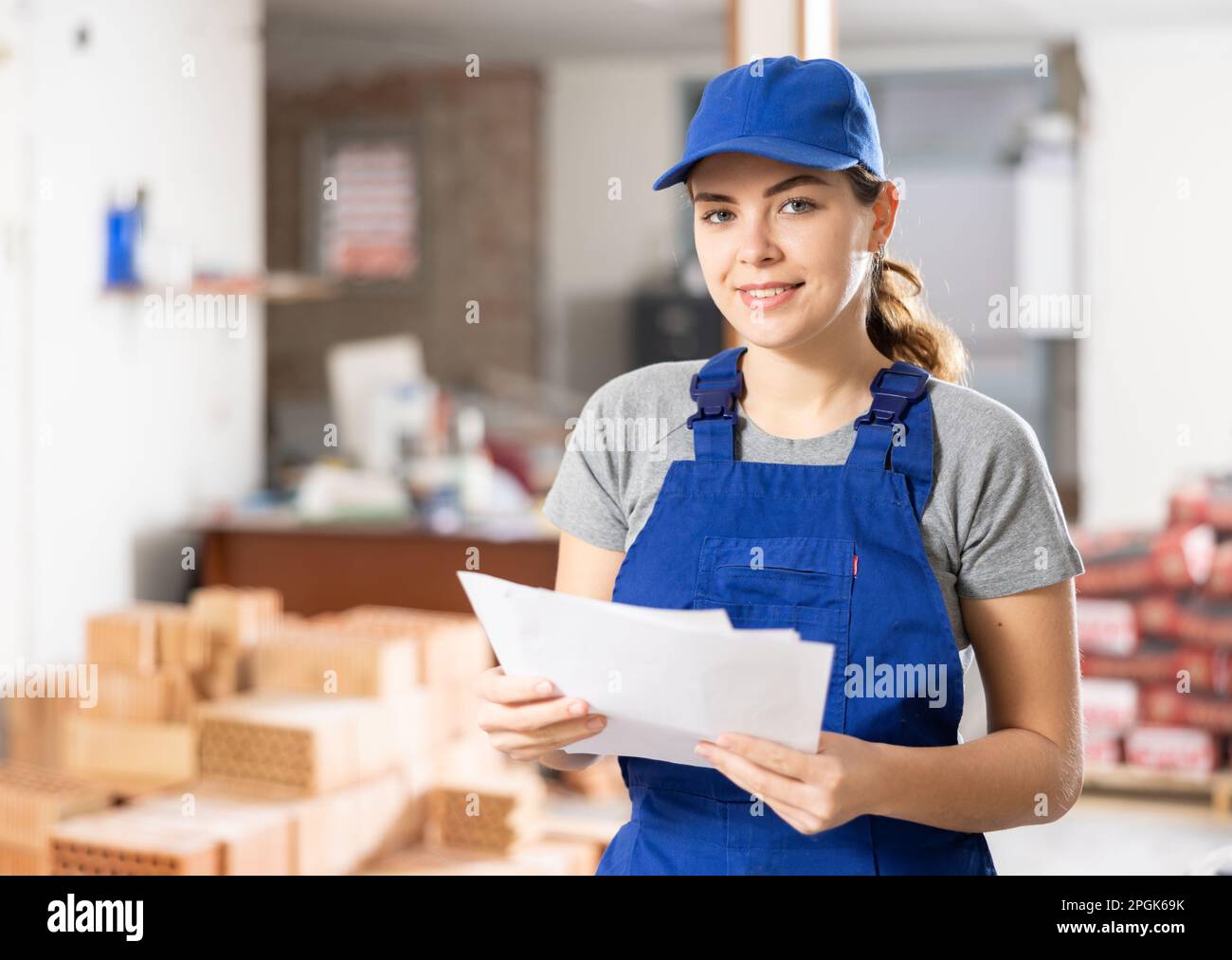 Woman foreman checking documents at building site Stock Photo - Alamy