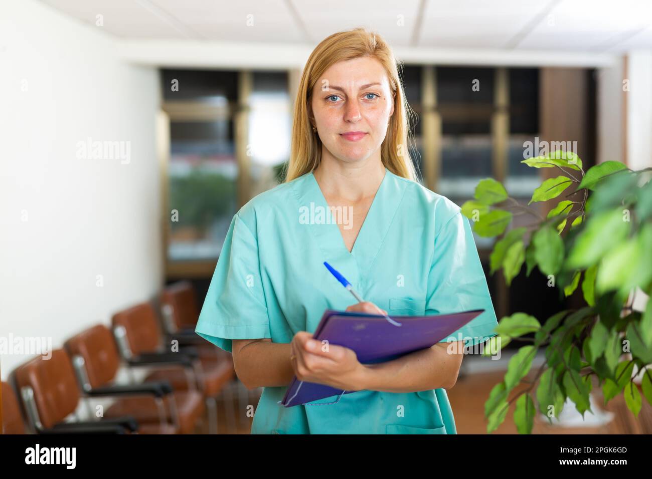 Female doctor assistant standing in medical office Stock Photo - Alamy