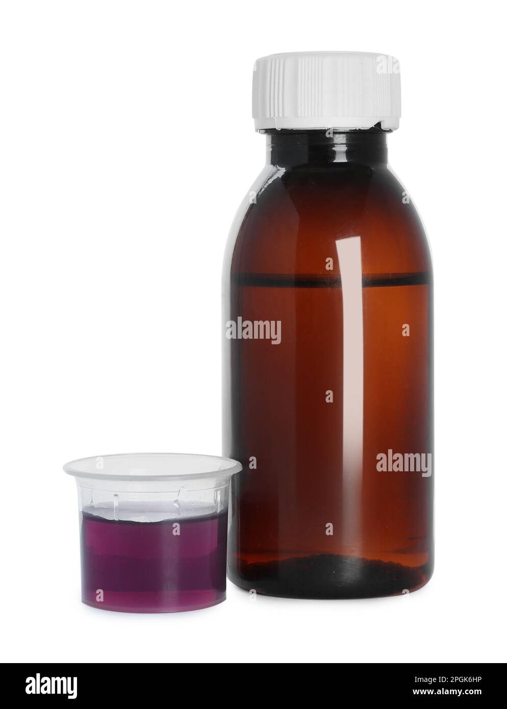 Bottle of cough syrup and measuring cup on white background Stock Photo ...