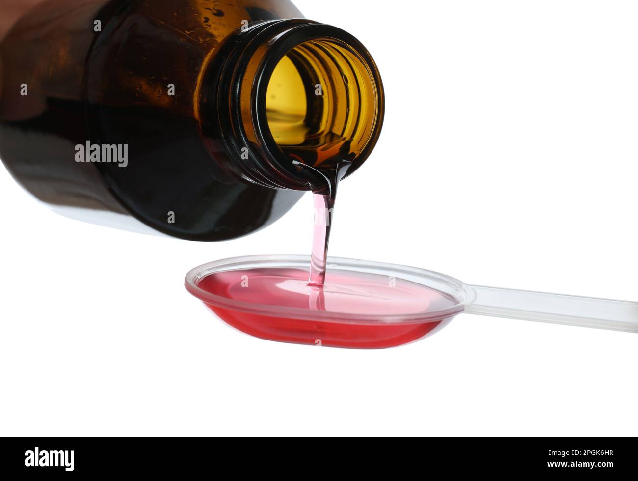 Pouring cough syrup into dosing spoon on white background Stock Photo ...