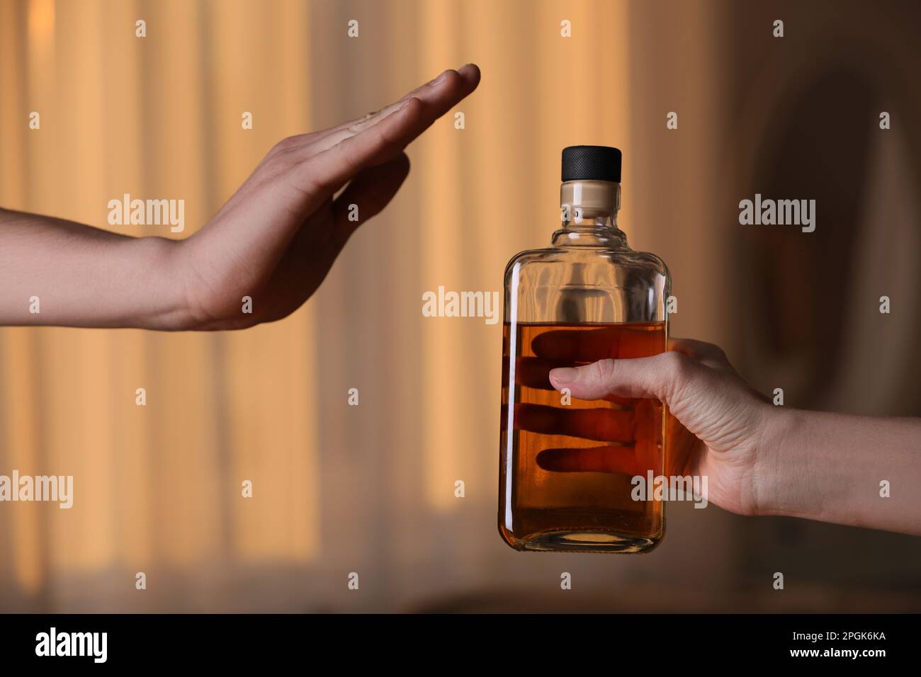 Man refusing to drink whiskey indoors, closeup. Alcohol addiction ...